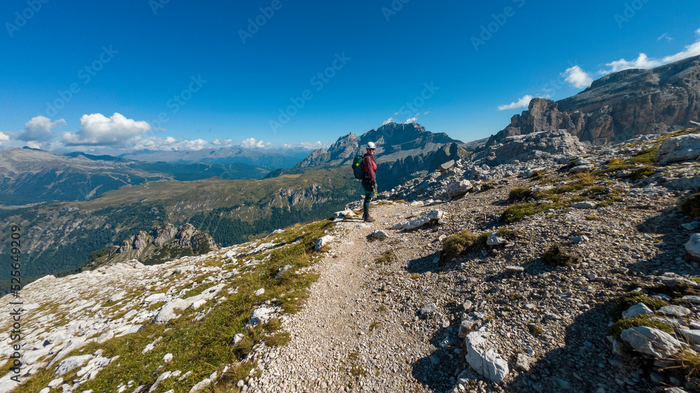 woman hiking the via ferrata "via delle bocchette" mountain sign in the ...