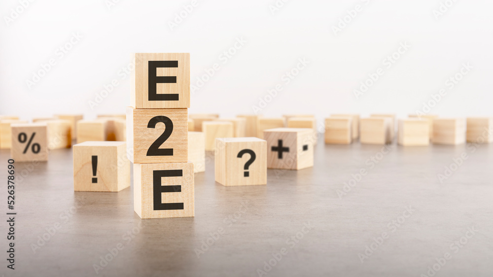 e2e text as a symbol on cube wooden blocks. many wooden blocks with ...