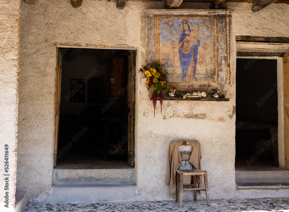 Side entrance at a historic Swiss farmhouse protected by a picture of ...