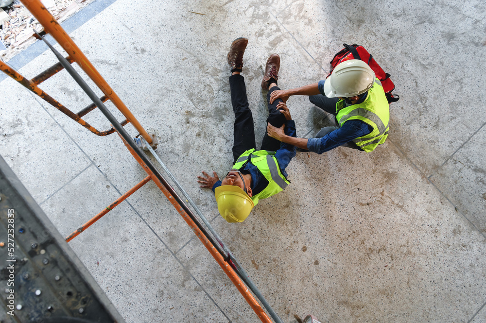 First aid support accident at work of builder worker in construction ...
