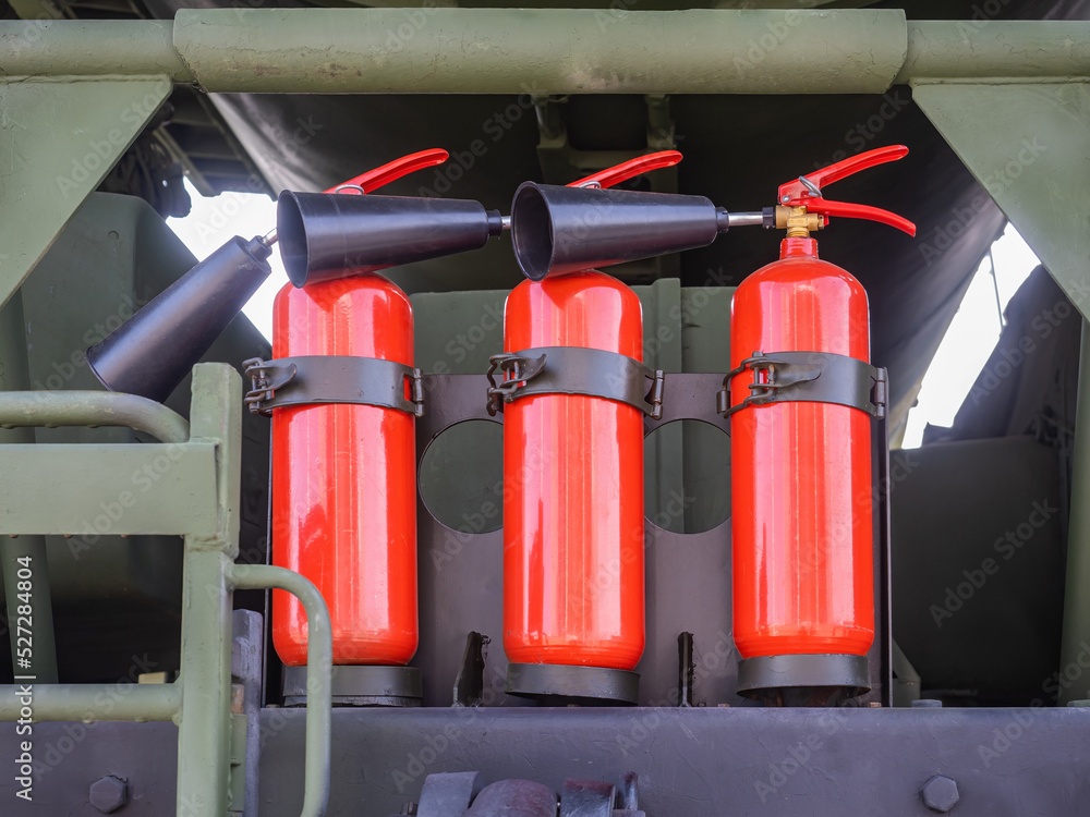Three fire extinguishers. Fire extinguishers with nozzles are fixed on ...