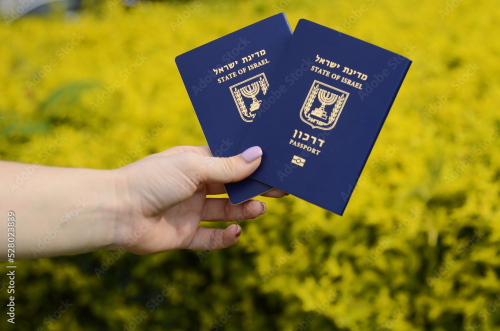 Israeli passport Darkon. A woman's hand is holding two Israeli ...