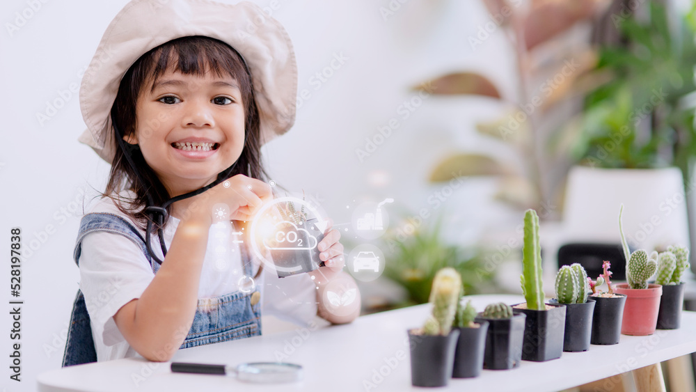 Little girl watching a plant. Environmental technology concept ...