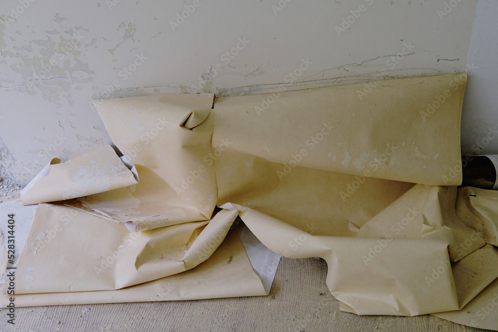 bare wall with wallpaper falling down, concept destruction of buildings ...