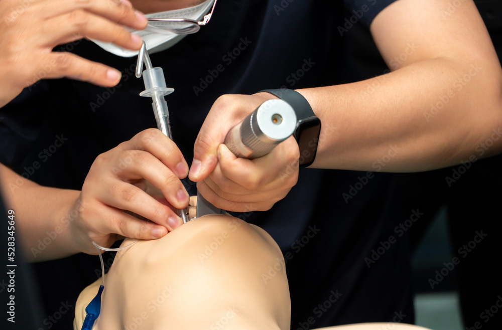 Anesthesiologist performing an orotracheal intubation on a simulation ...