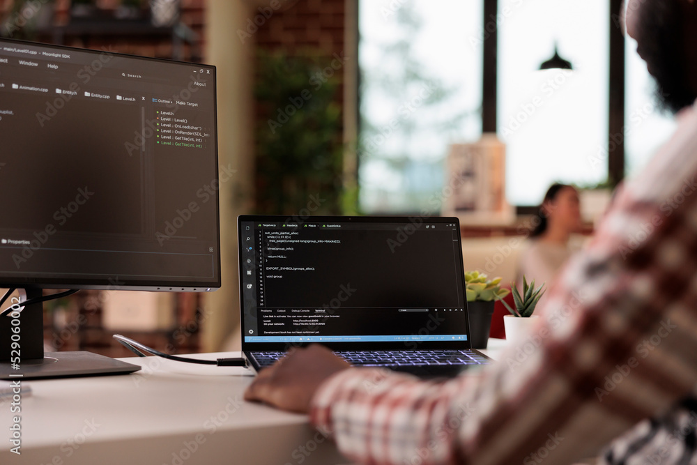 Software developer programming firewall security on multiple monitors, learning new user ...
