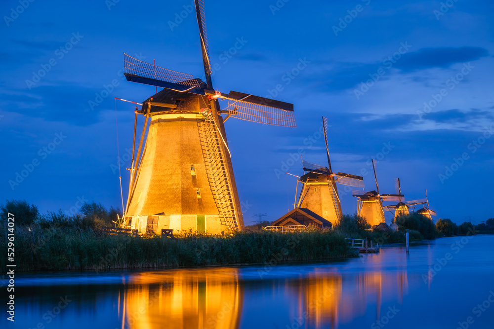 Kinderdijk National Park in the Netherlands. Windmills at dusk. A natural landscape in a ...