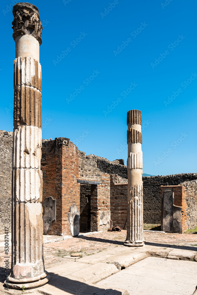 Two ancient marble pillars standing in front of ancient roman house ...