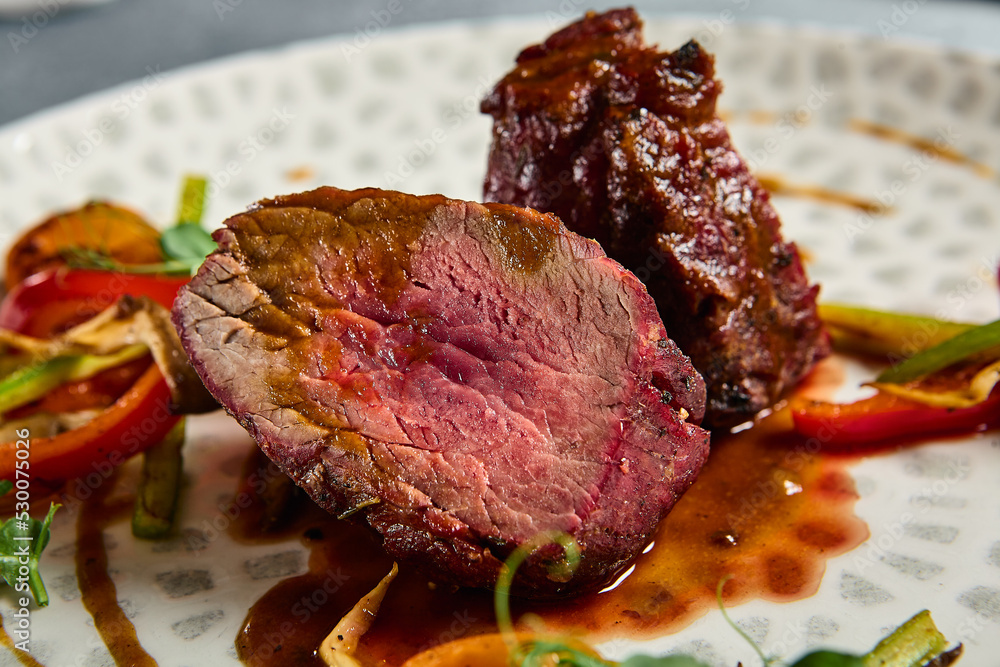 Roasted Beef fillet with vegetables. Roasted Mignon steak with paprika ...