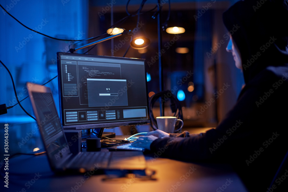 cybercrime, hacking and technology concept - female hacker in dark room writing code or using ...