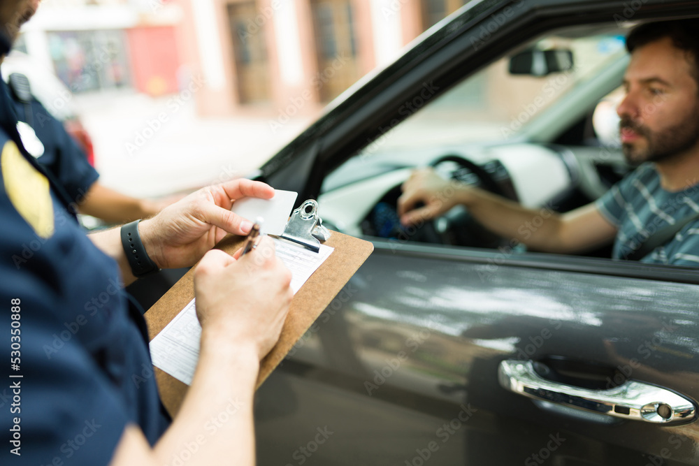Police officer making a speeding ticket for a driver Stock Photo ...