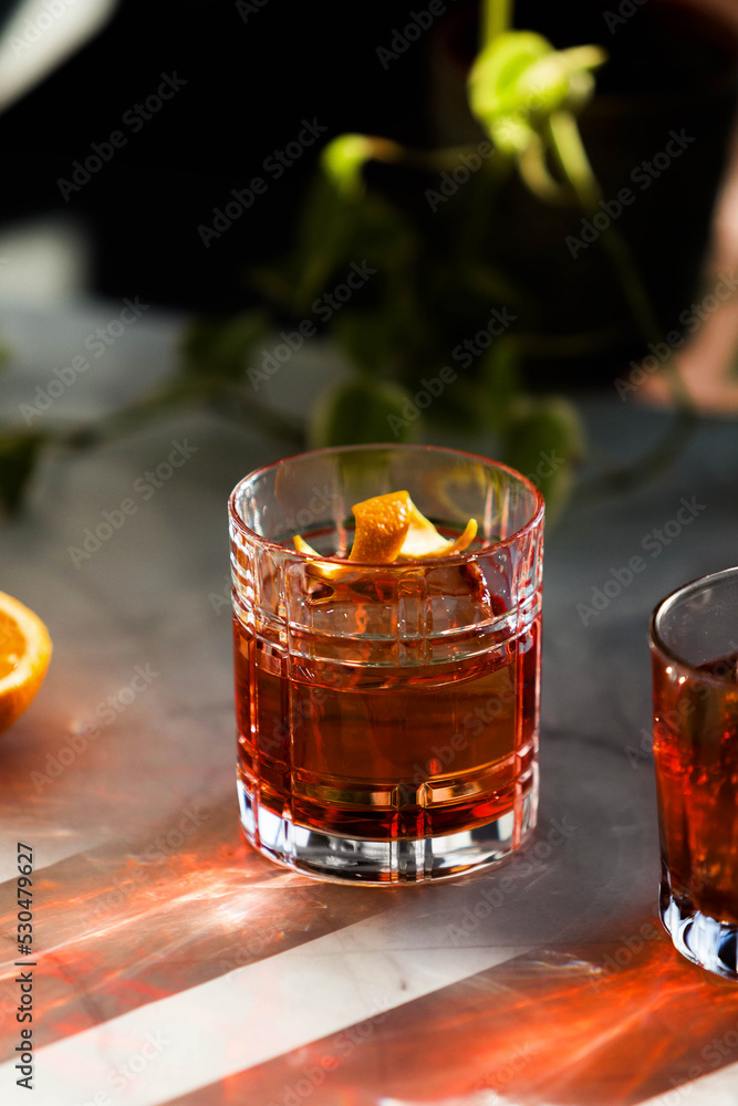 ภาพถ่าย Stock Photo composition of two Negroni cocktail glass with sun ...