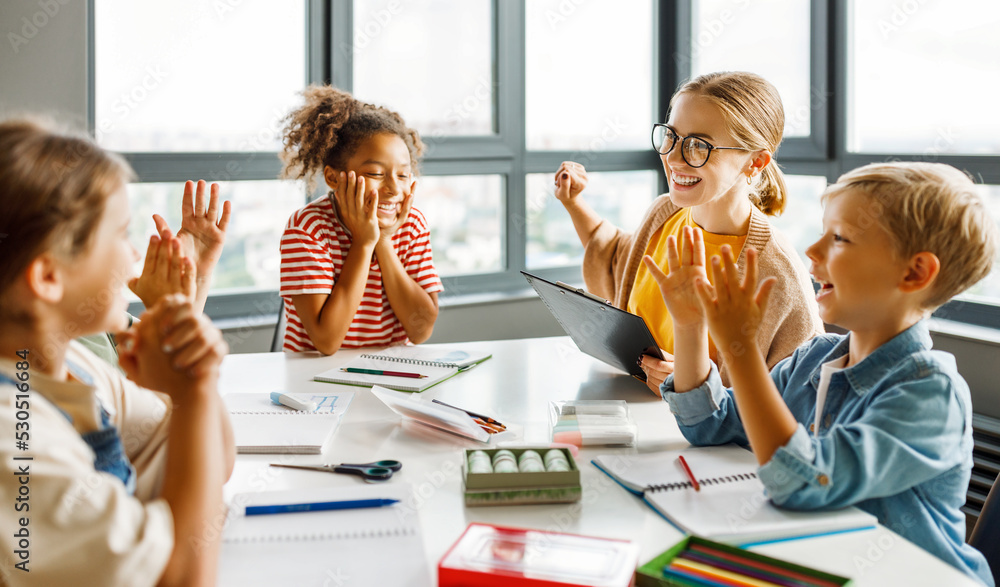 Teacher and joyful students celebrate successful completion of ...