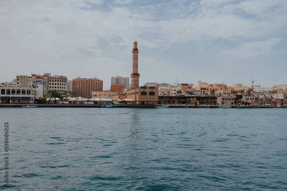View of Dubai Creek channel with traditional Abra boats and piers ...