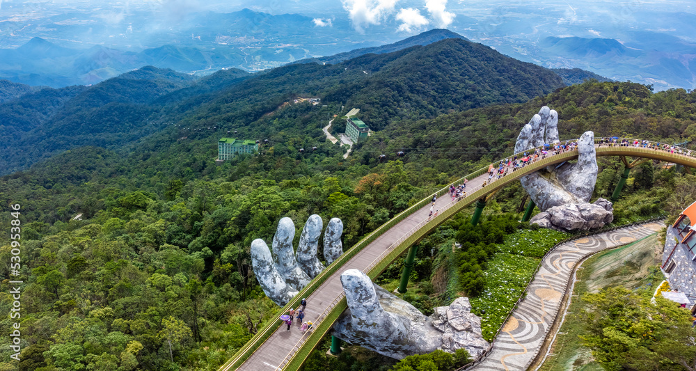 Golden Bridge lifting by two giant hands in the tourist resort on Ba Na ...