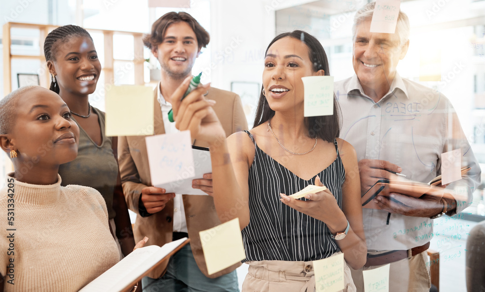 Team of workers in office, brainstorming together and writing idea on ...