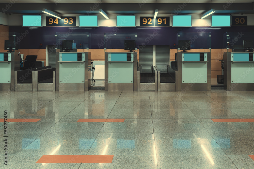 A row of empty check-in cabins in an international airport with small ...
