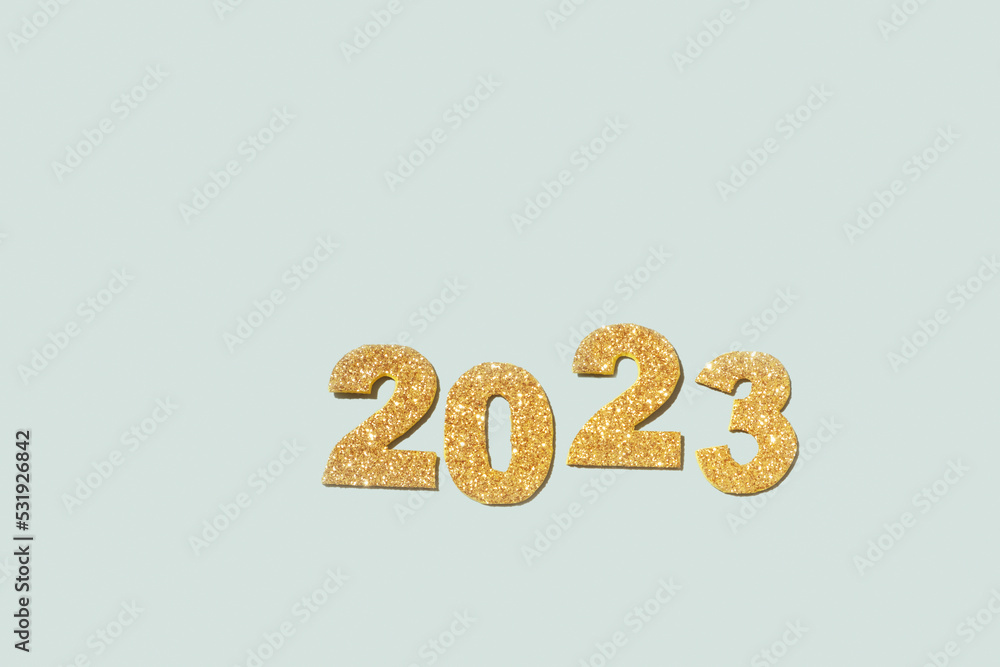 Golden glitter of the numbers 2023 is a symbol of the coming new year ...