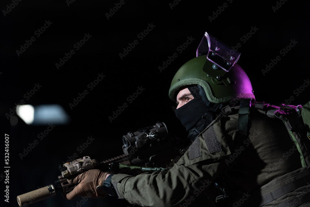 Army soldier in Combat Uniforms with an assault rifle and combat helmet ...