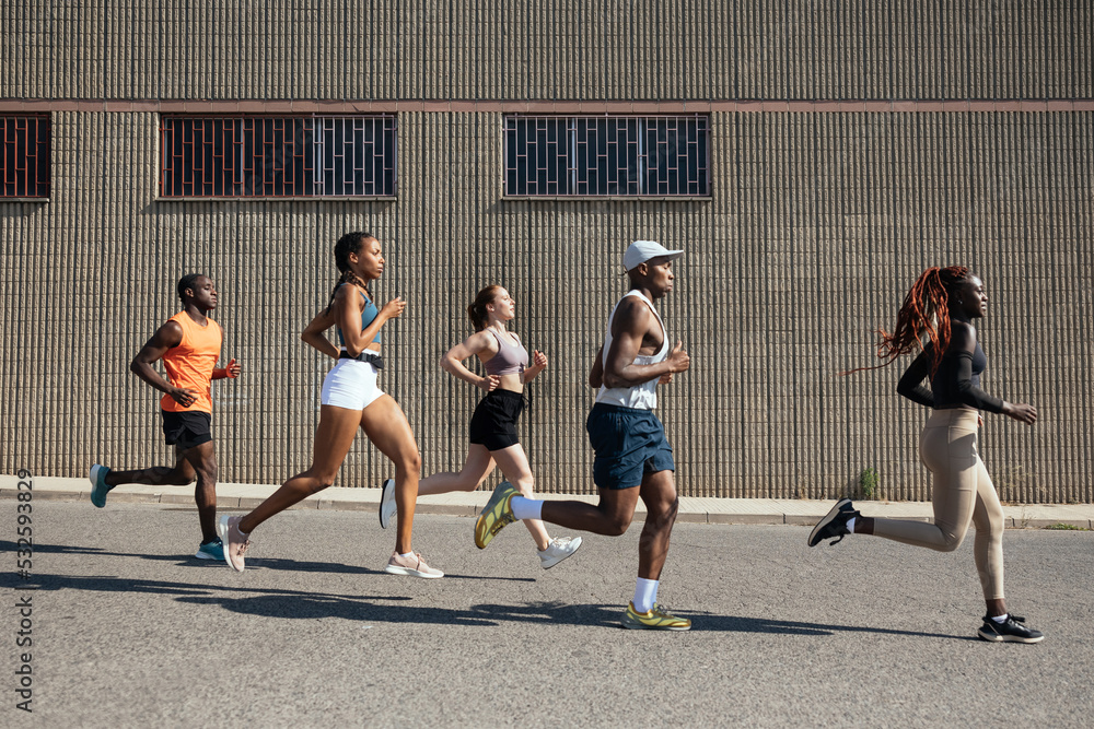 Strong male and female athletes running on slope Stock Photo | Adobe Stock