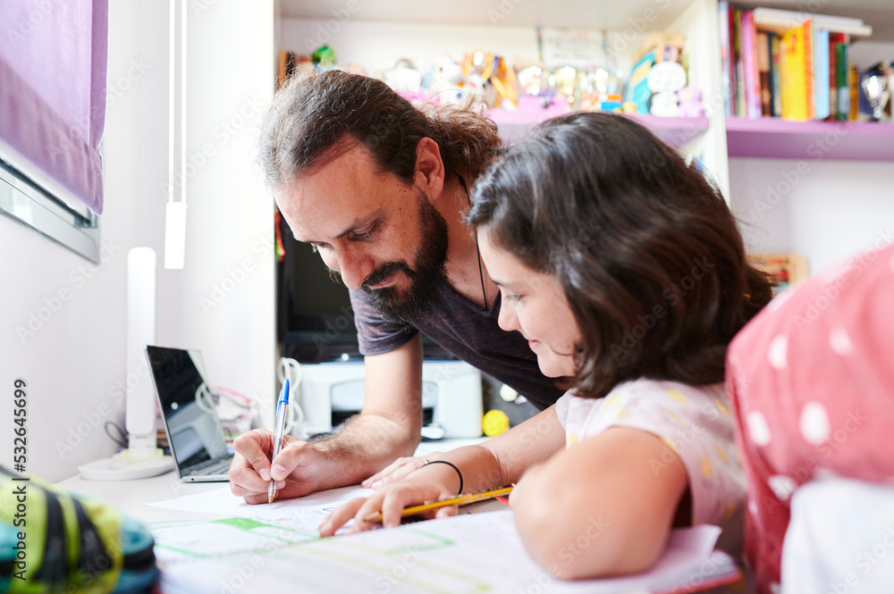 Dad helping his daughter do homework Stock Photo | Adobe Stock