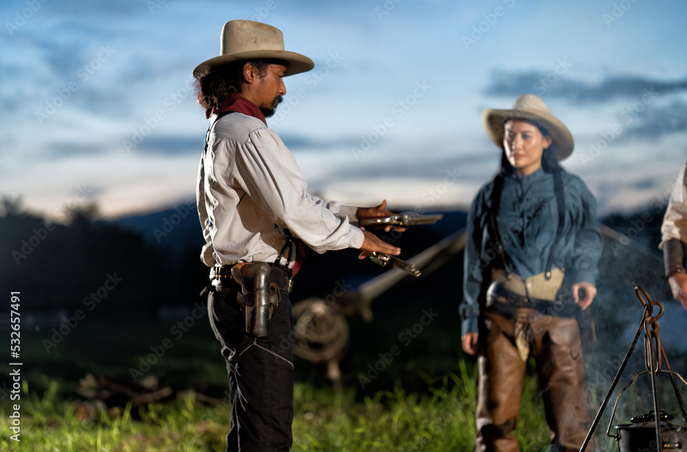 Cowboy man standing at the green land near mountain side practice ...