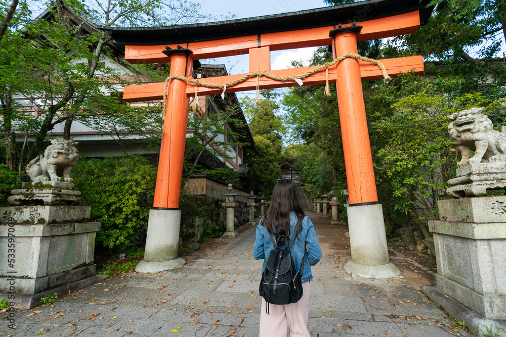rear view of asian Japanese girl backpacker walking towards the red ...