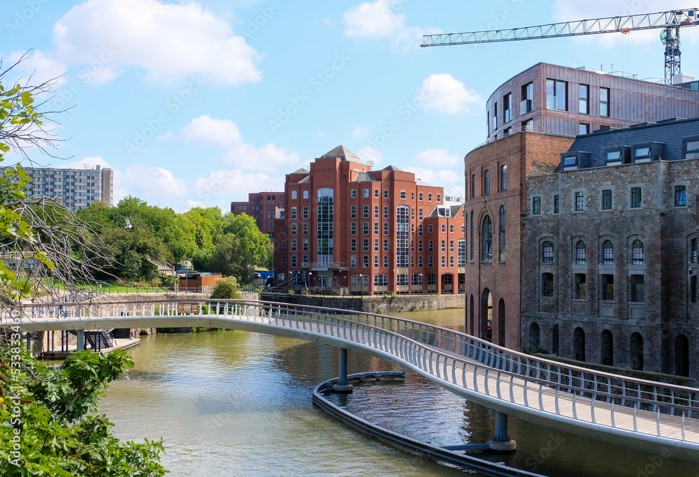 Winding pedestrian walkway bridge over Avon River lined by beautiful ...