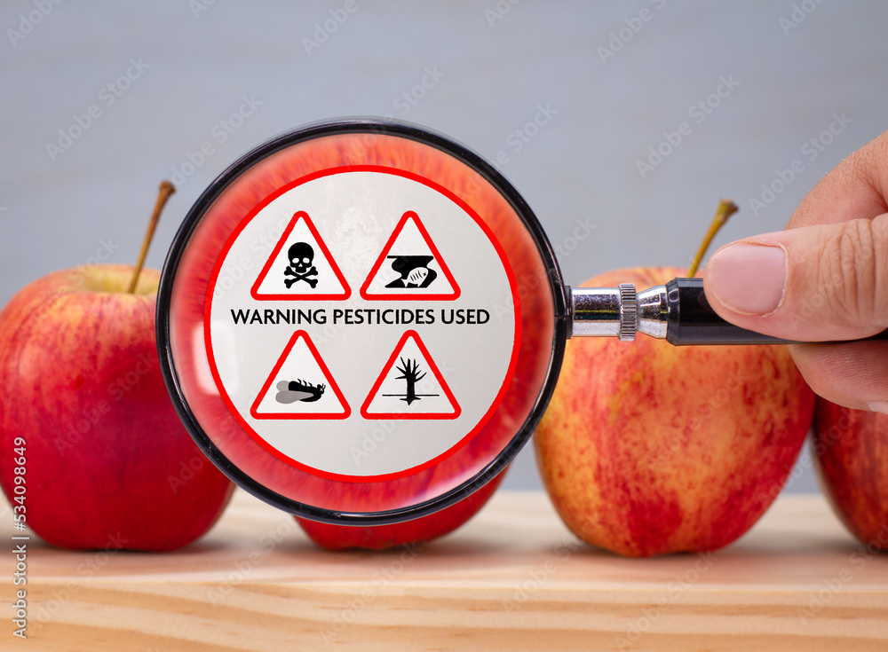 Magnified label on apple, warning of environmental damage caused by ...