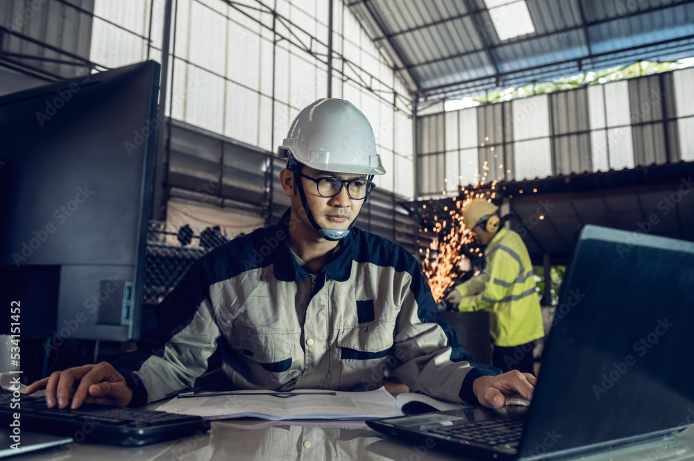 Asian project engineers who control production line facilities Use ...