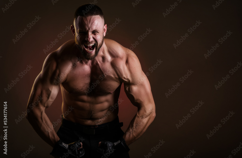 Studio portrait of fighting muscular man in black fighting gloves ...