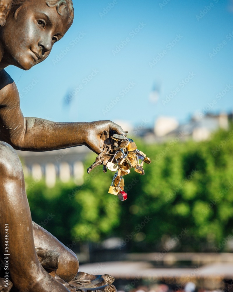 Bronze statue of an angel holding the locks and keys that lovers heng ...