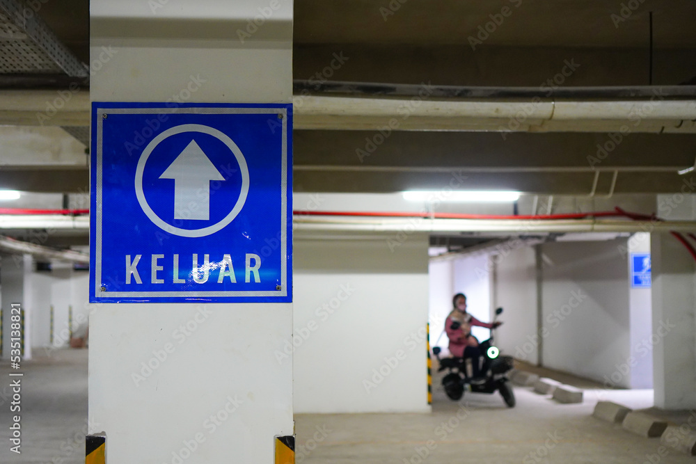 Exit sign symbol in basement with biker as background. Underground ...