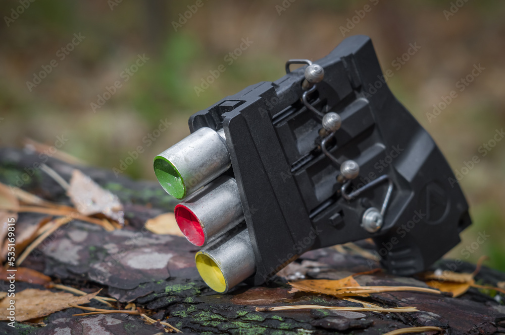 A signal pistol with a cassette of three colored illumination rockets ...