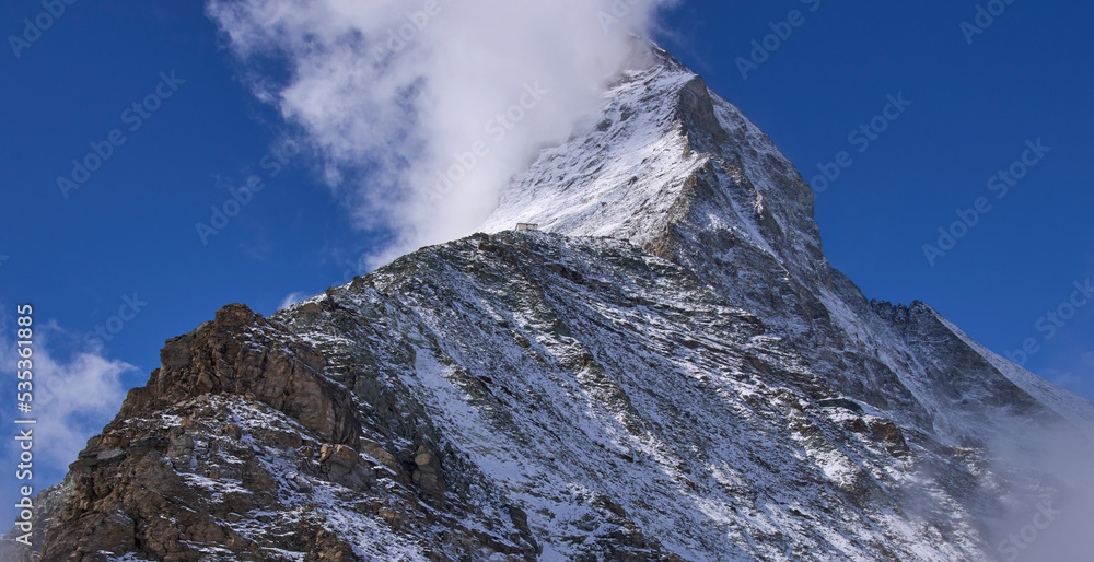 Hornli ridge separating east and north faces of iconic mount Matterhorn ...