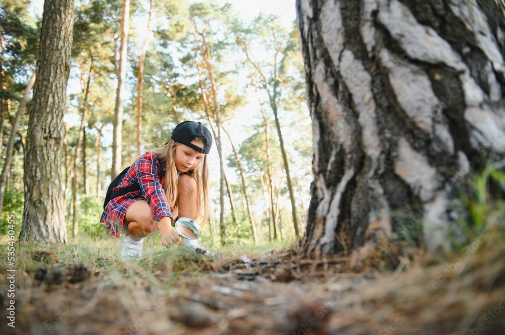 Image of cute kid with magnifying glass exploring the nature outdoors ...