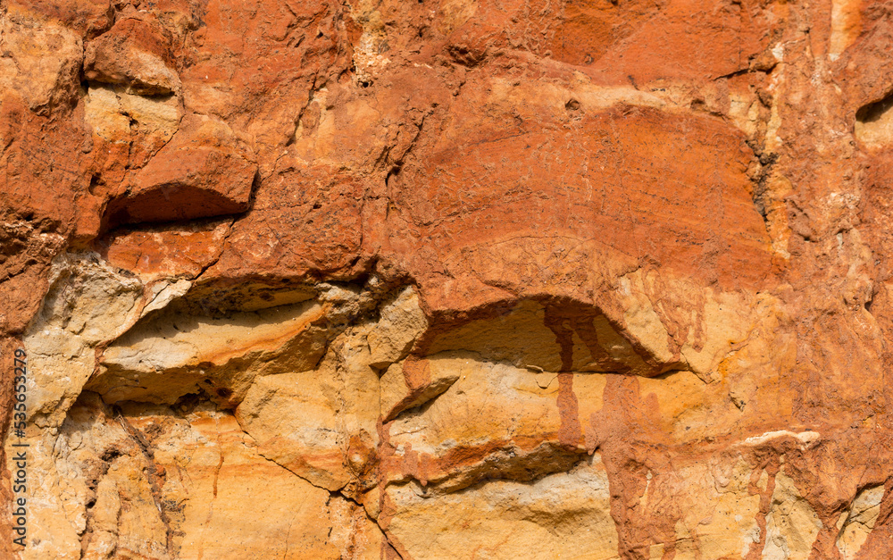 Sedimentary rocks with a high content of iron oxide. Red soil, loam ...
