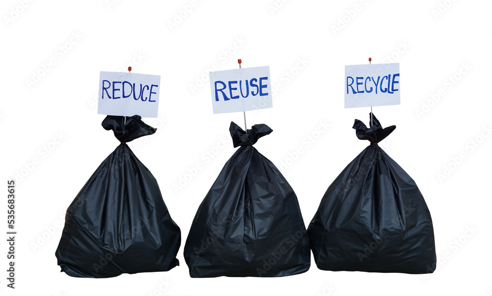 Paper signs with words "REDUCE""REUSE" "RECYCLE" on black plastic bags ...