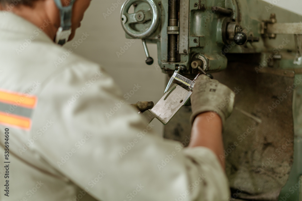 engineer or factory worker using vernier calipers for finding to set ...