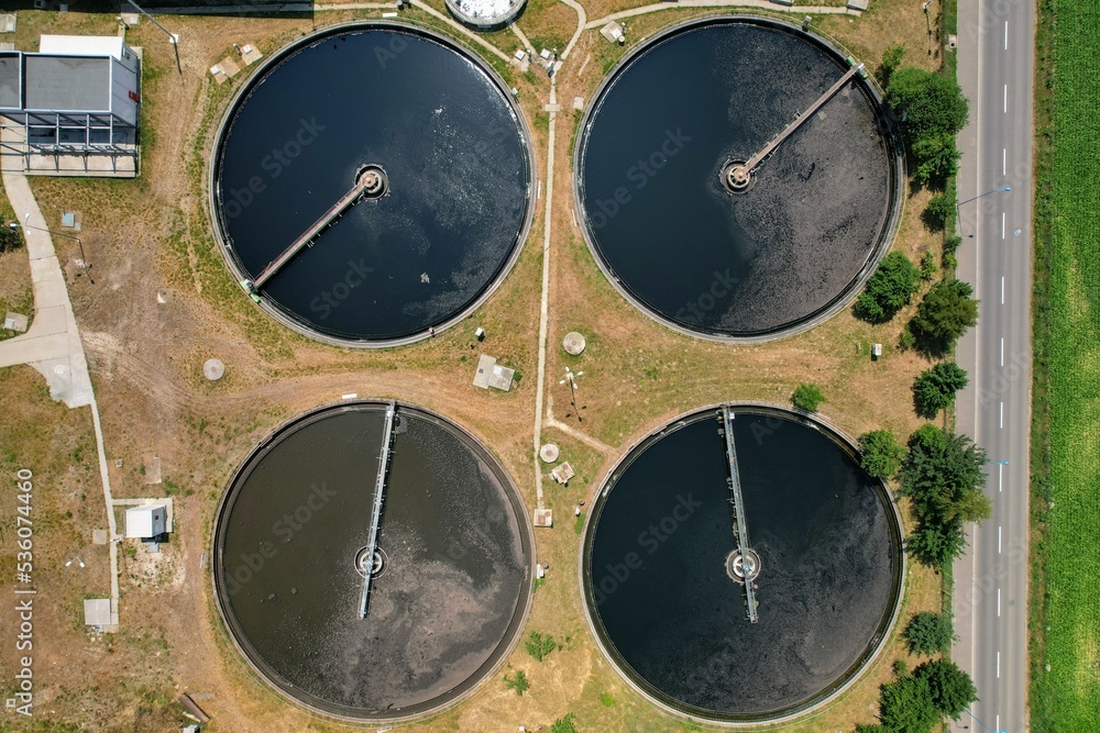 Aerial view of circular clarifier tanks with surface skimmer, part of a ...