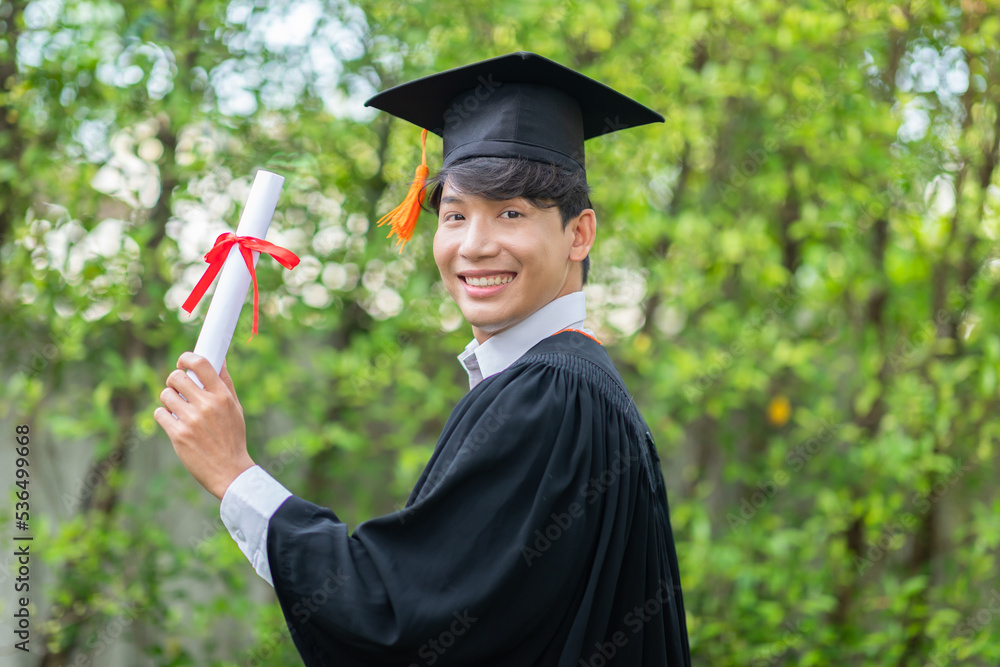 Foto Asian Graduate man put hands up and celebrating with certificate ...