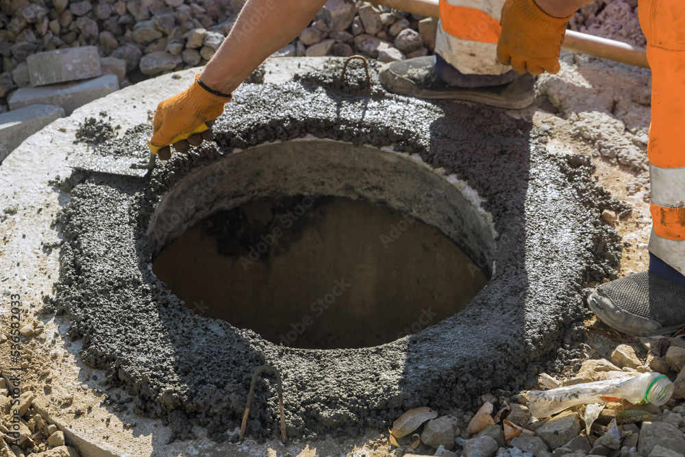 There is utility worker who is constructing pit for septic tank the ...