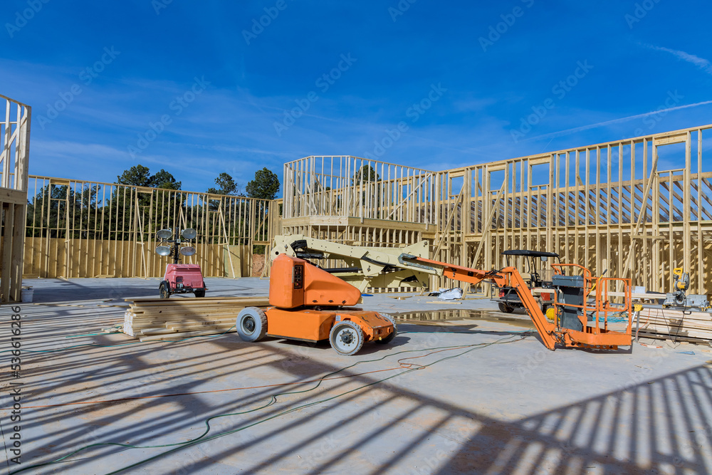 Contractor using boom truck forklift at construction site where framing ...