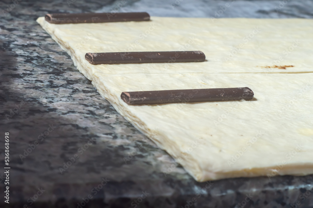 Baker making pain au chocolat before going to the oven,bakery concept ...