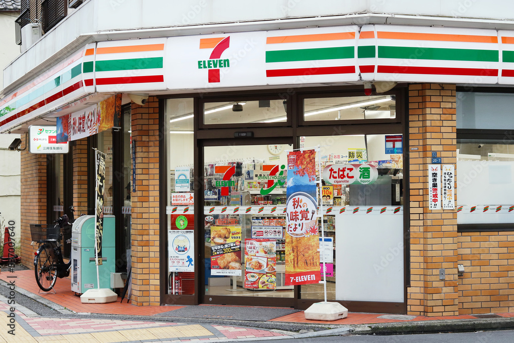 TOKYO, JAPAN - October 8, 2022: Front of a 7-Eleven convenience store. The store is in Tokyo's ...