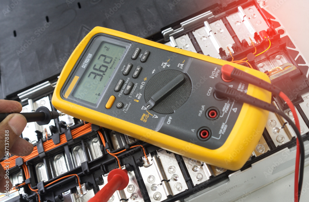 Selective focus Testing Lithium battery cells with digital multimeter ...