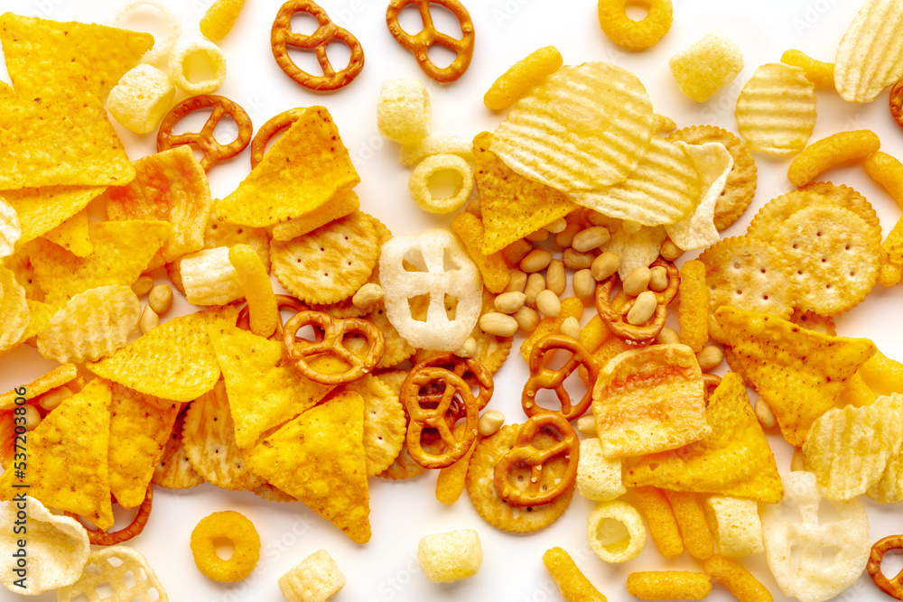 Salty snacks texture on a white background. Party food assorted mix ...