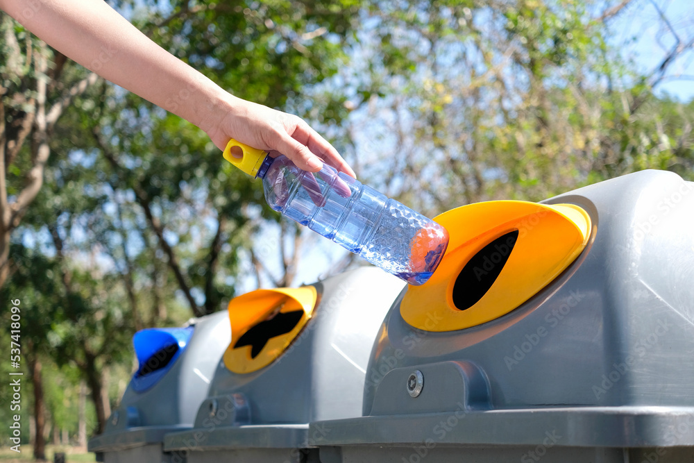 Please dispose of plastic bottle into the tank. A man throw rubbish in ...