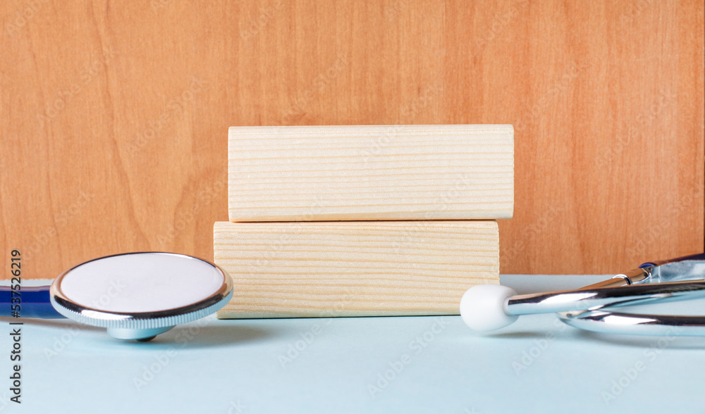 Place to insert text on wooden blocks and stethoscope on desktop ...
