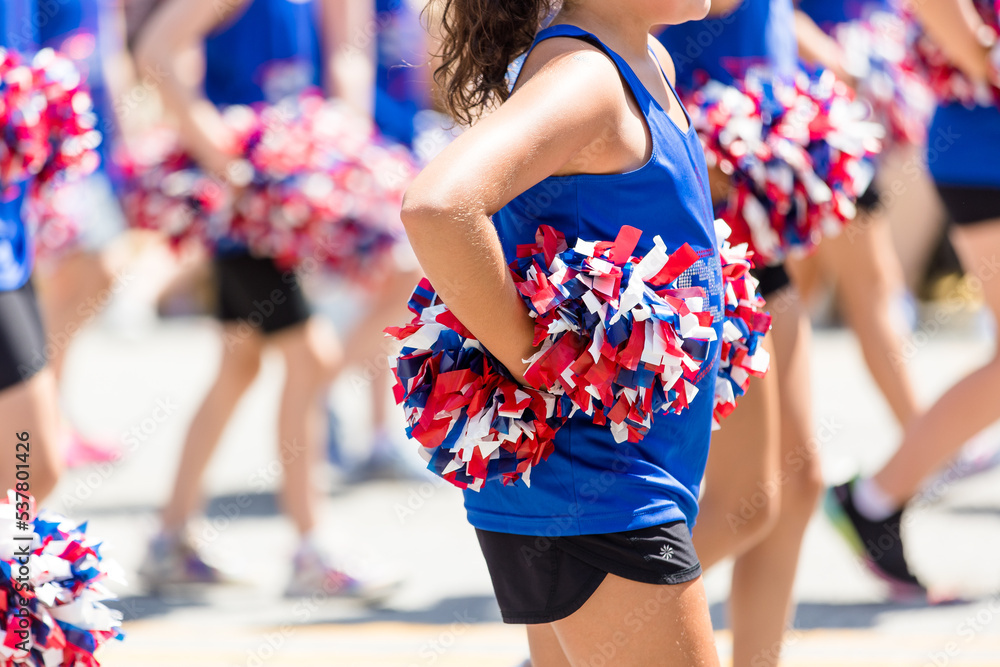 Cheerleader Holding Red, White, and Blue Pom Poms at Fourth of July ...